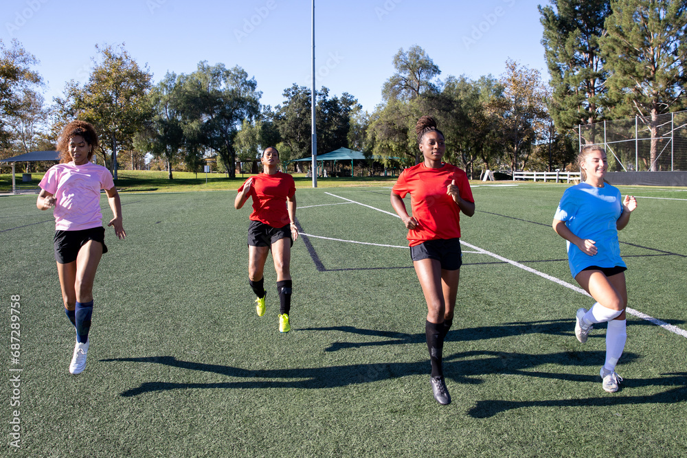 Group of five female soccer players on a team warming up and running ...