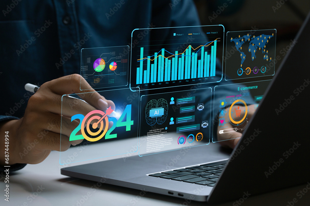 Businessman works on laptop Showing 2024 business trends dashboard with ...