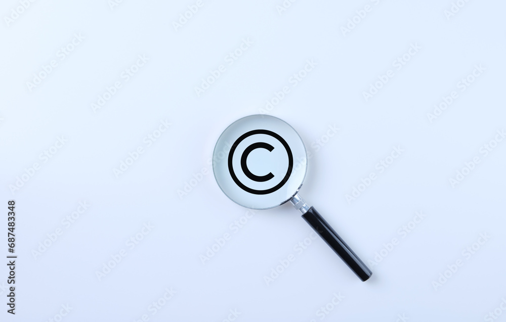 Copyright protection and patenting concept. Magnifying glass magnifies ...