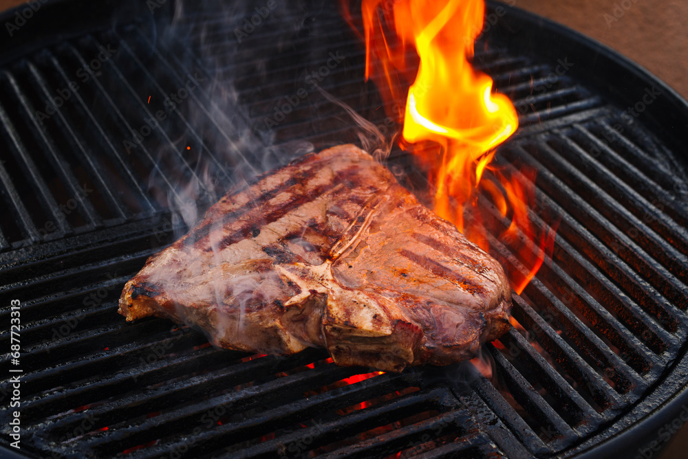Barbecue dry aged wagyu porterhouse beef steak grilled as close-up on a ...