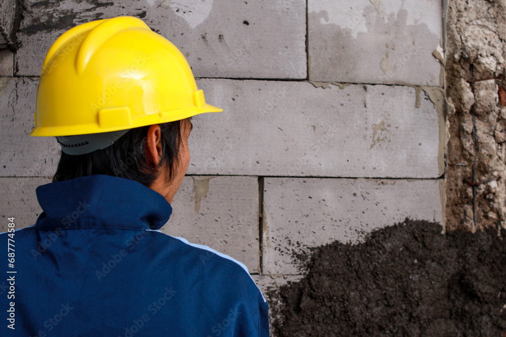 Labor wear safety helmet standing and looking at construction site ...