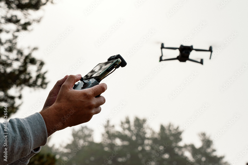 Photo Stock Photograph of man hands holding the remote control of a ...