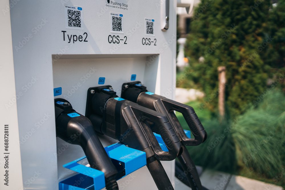 Close Up EV charging at station. Eco and clean energy concept ...