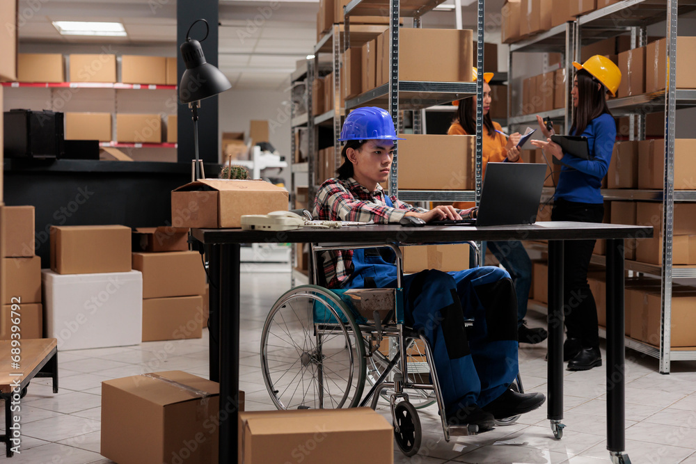 Shipment warehouse worker in wheelchair processing customer order on ...