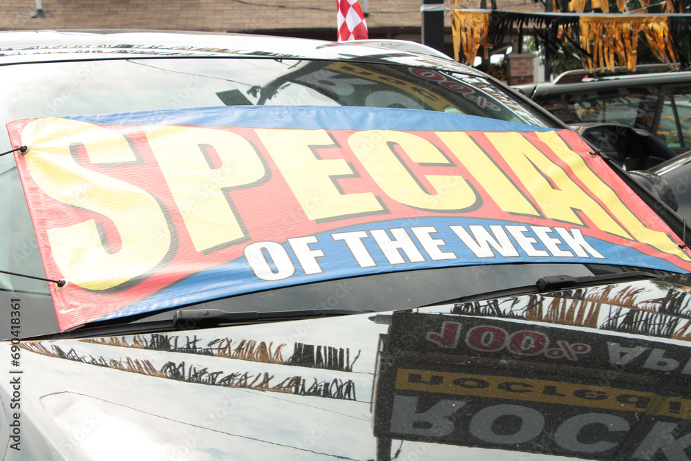 special of the week words text sign banner flag on front of car vehicle ...