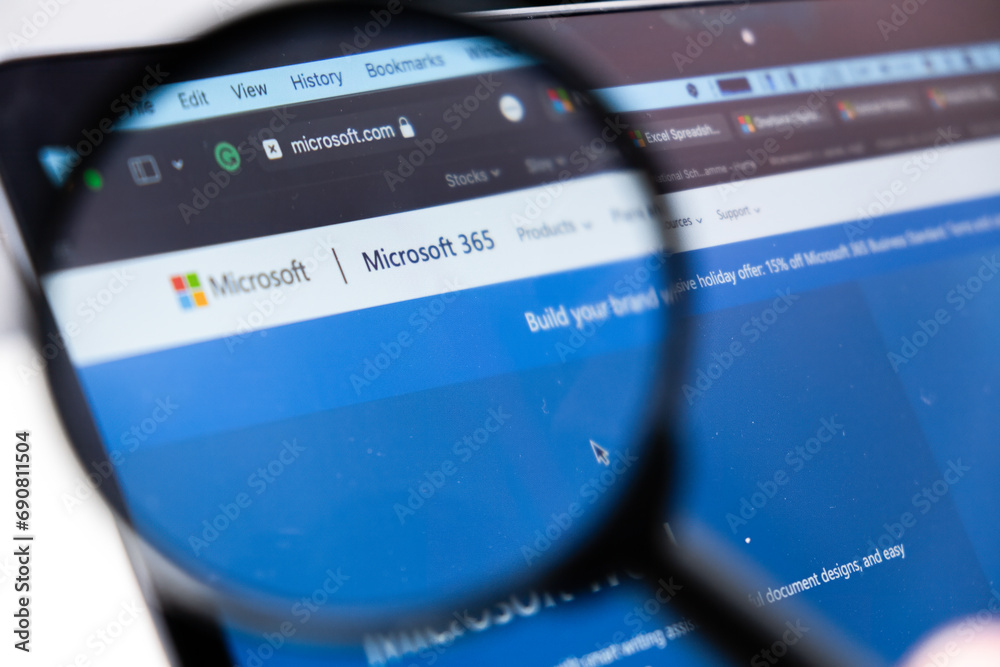Microsoft 365 logo on the screen of laptop through magnifying glass ...