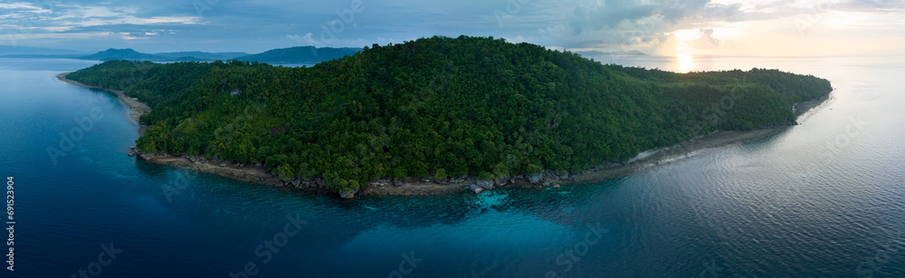Early morning rain clouds drift near the beautiful island of Ambon ...