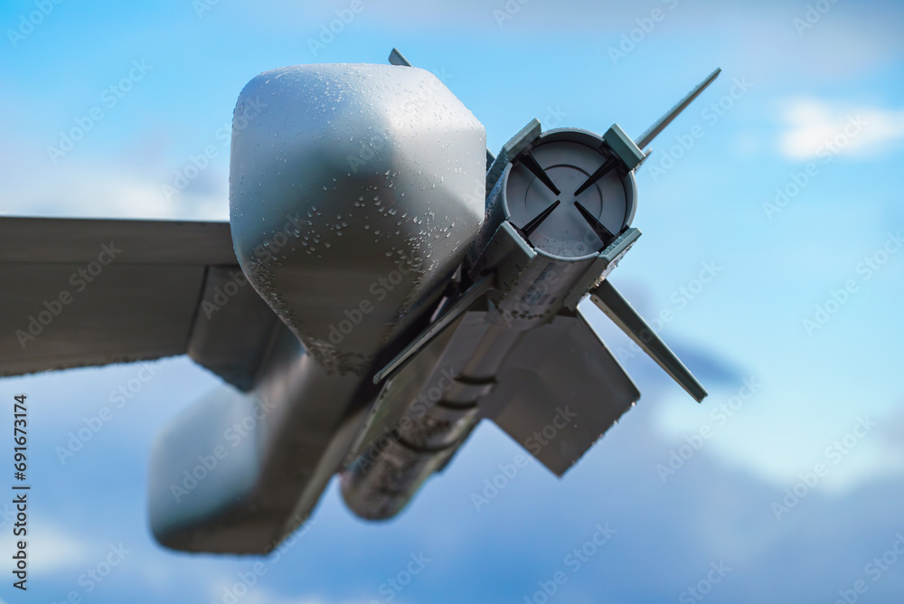 Part of a military fighter aircraft. Cruise missile on the wing of a ...