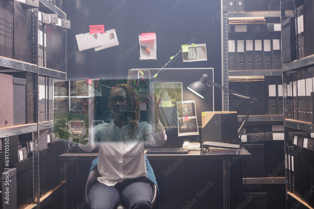 Woman detective looking at evidence in hologram, examining augmented ...