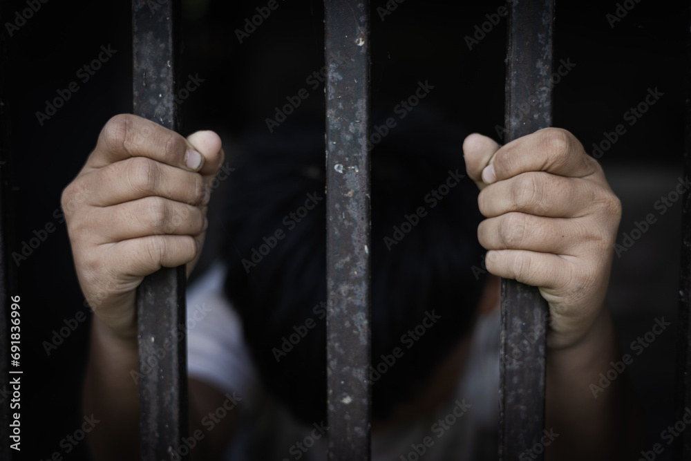 The child captured the iron cage with sadness and despair. The concept ...