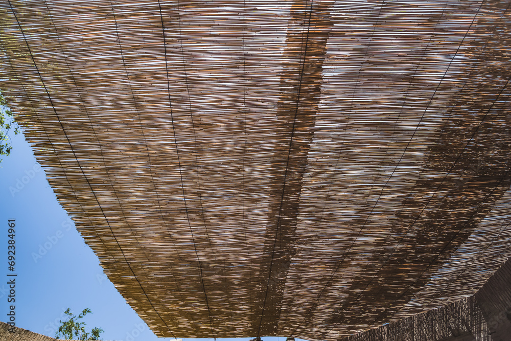 Reed roofing protects from heat and creates shade in hot climates in ...