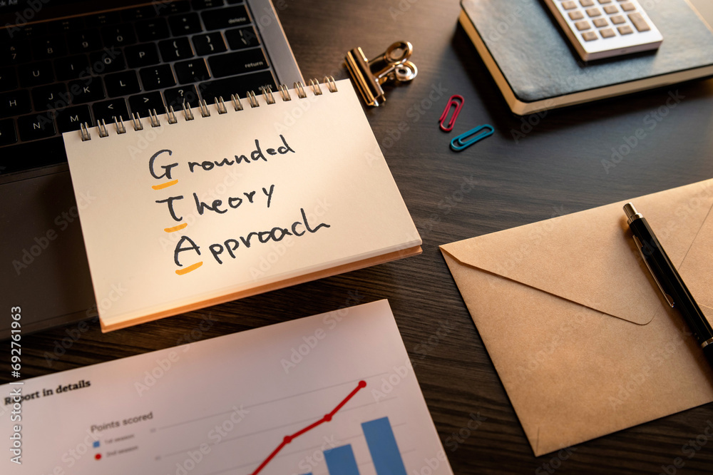There is notebook with the word Grounded Theory Approach. It is an ...
