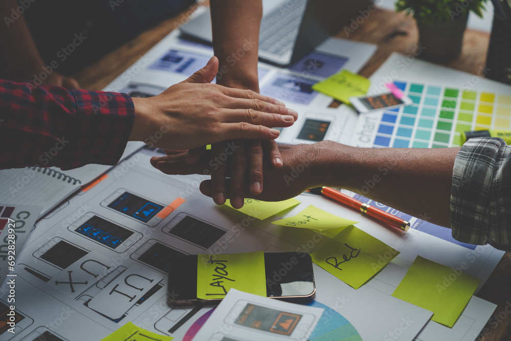 Design team, ux ui developers join hands to brainstorm on the design of ...