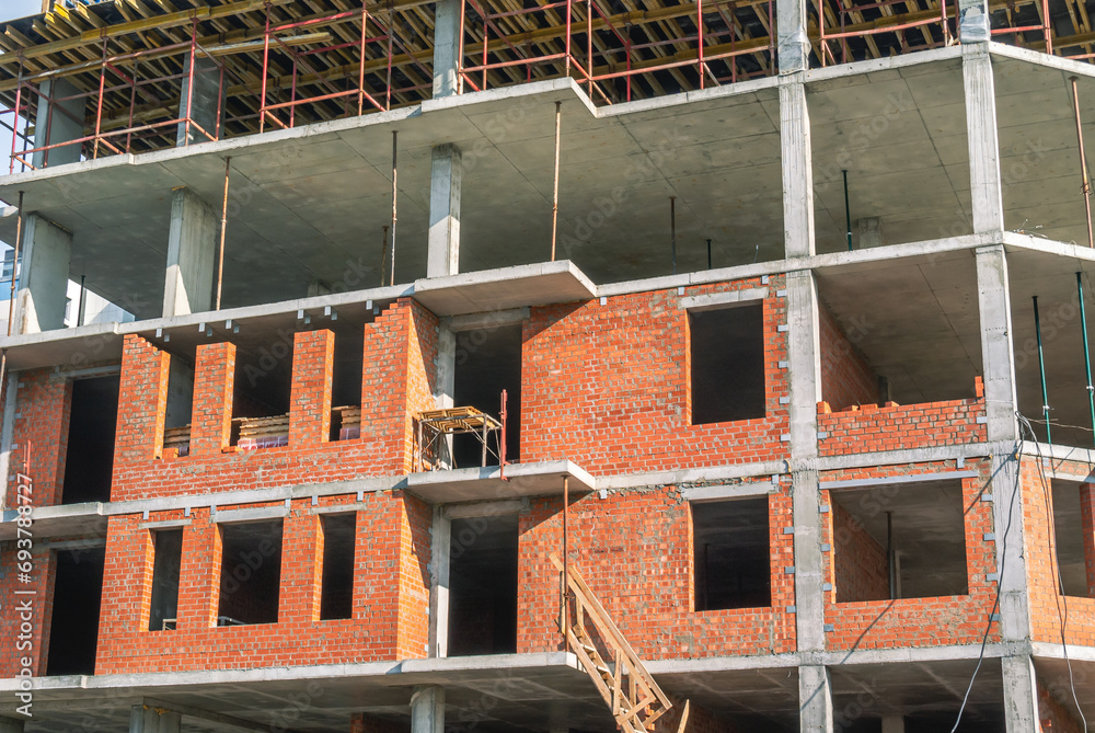 Installation of partitions and exterior walls made of red brick. The ...