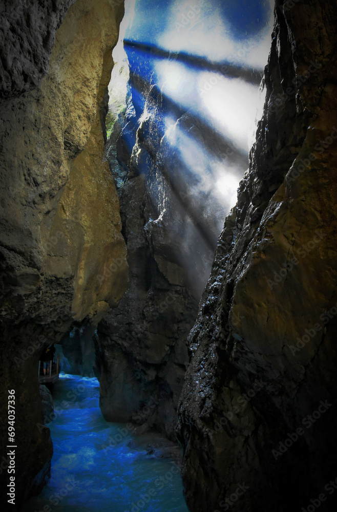 The picturesque gorge of the Partnach River with waterfalls, a rushing ...