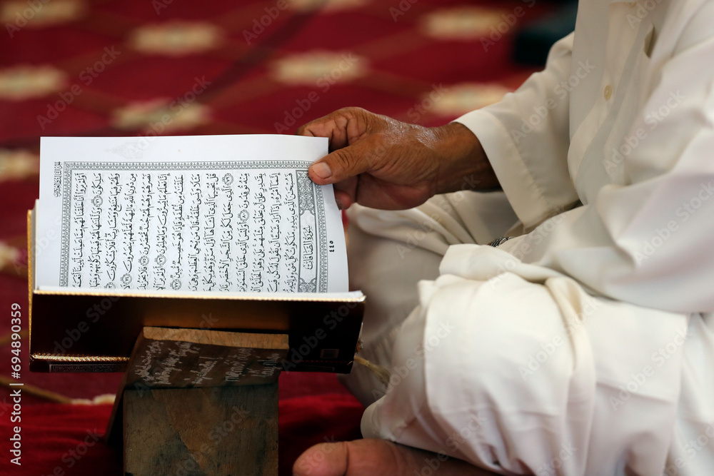 Muslim man reading an Arabic Holy Quran (Koran), Masjid Ar-Rohmah ...