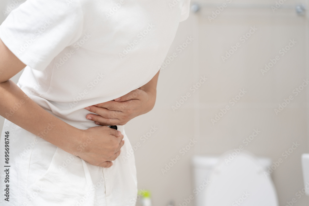 Constipation and diarrhea in bathroom. Hurt woman touch belly stomach ...