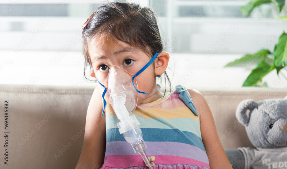Kid girl making makes inhalation nebulizer steam sick cough at home ...