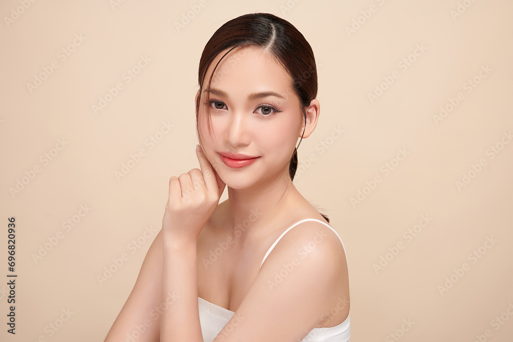 Beautiful young asian woman with clean fresh skin on beige background ...