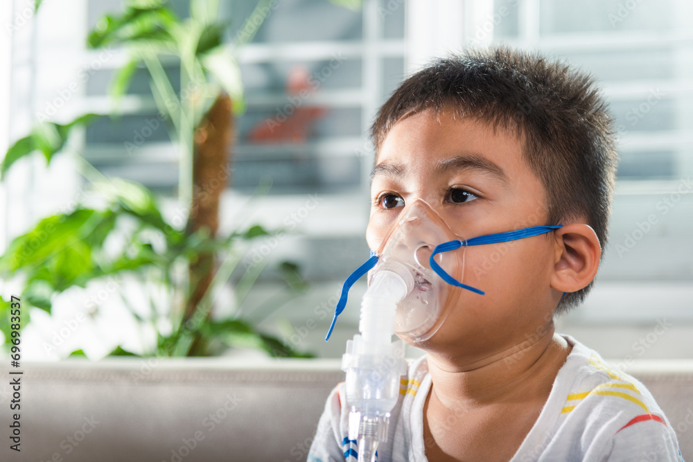 Asian Child using nebulizer mask equipment alone have smoke, Kid boy ...