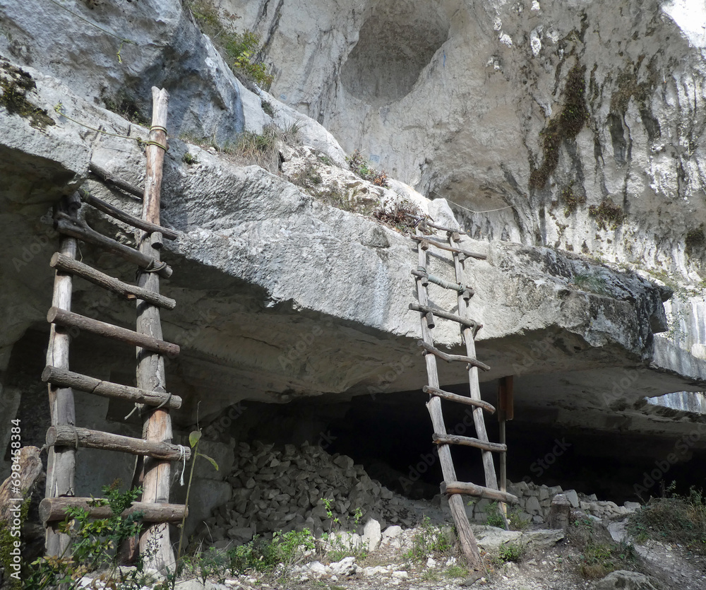 cave dug into the rock used in prehistory by primitive men as shelter ...