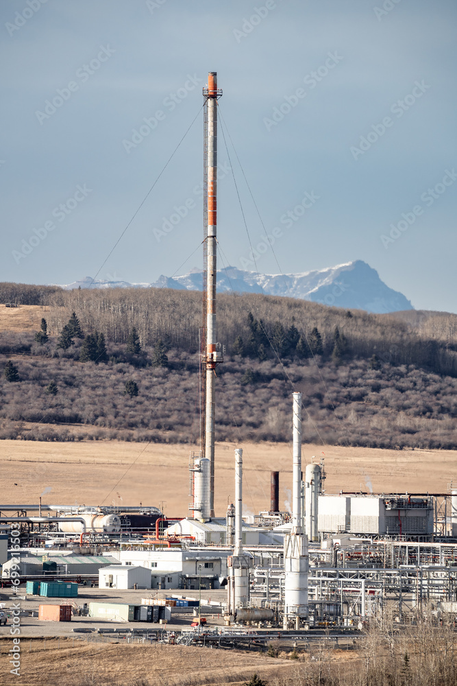Rural Alberta gas plant with flare stack and industrial equipment ...
