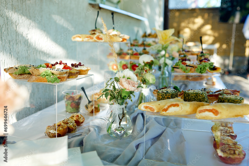 catering. Outdoor buffet table displays variety of appetizers on ...