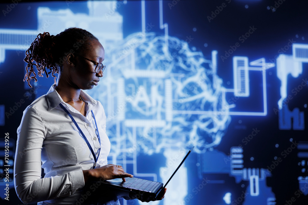 Tech support uses laptop to develop artificial intelligence neural networks nodes modeled after ...