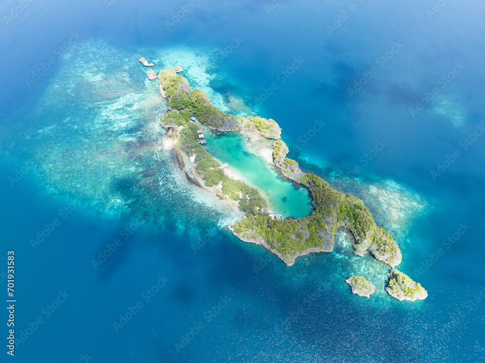 Foto de Stock Rufas Island is fringed by beautiful coral reefs in Raja ...