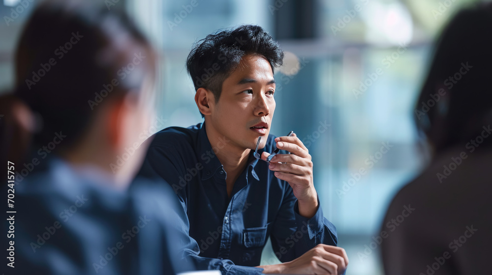 Man in a conversation, gesturing with his hands while speaking to an ...