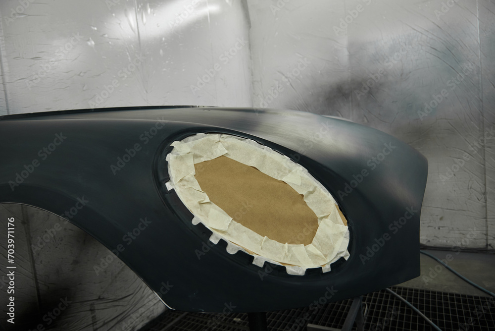 The photograph captures the scene of an automotive workshop, showcasing ...