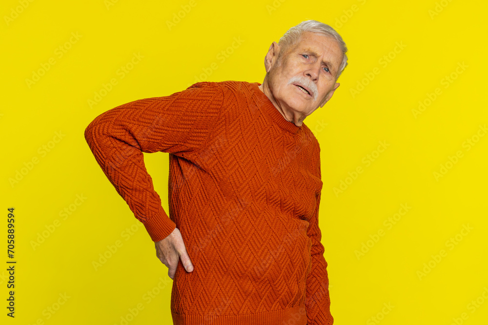 Senior old man suffering backache, massaging sore place lower spine ...