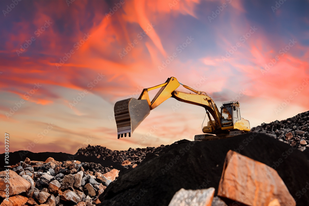 Excavator on earthworks at construction site on sunset background ...