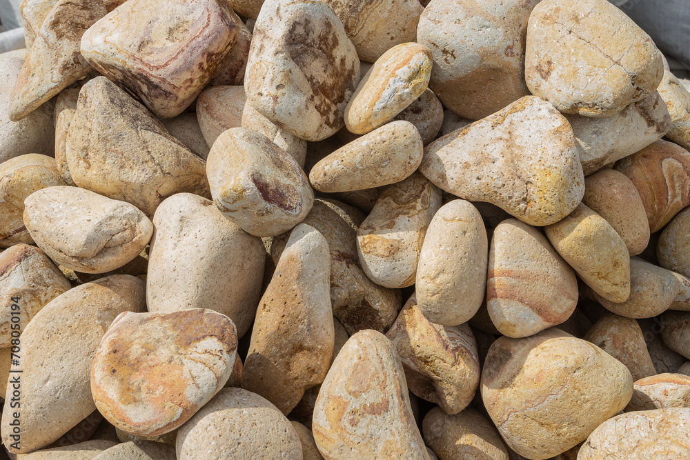 Beige Pebble stones including occasional cream inclusions closeup ...