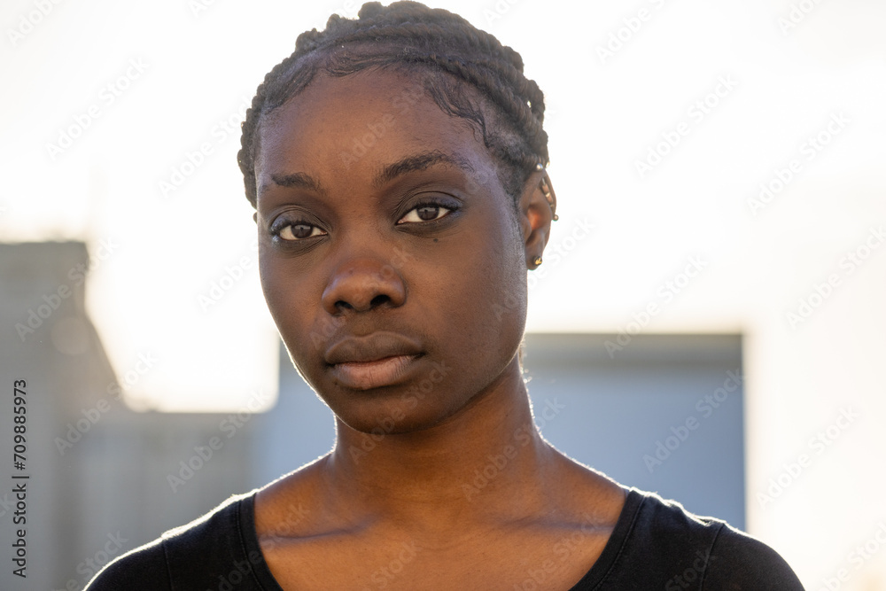 This portrait captures a young woman with a thoughtful, introspective ...