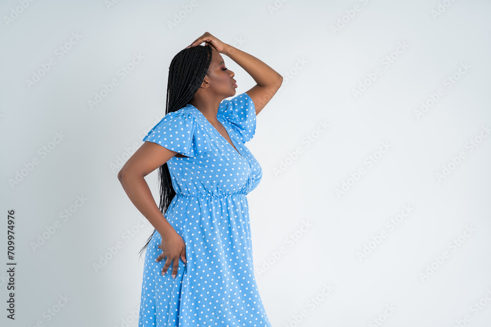 Plus size female model posing in blue dress on white background, young ...