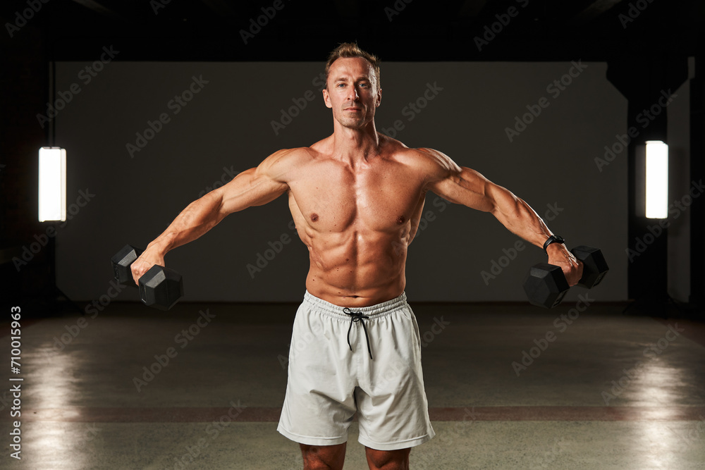 The man's chiseled abdomen and powerful chest muscles are on full ...
