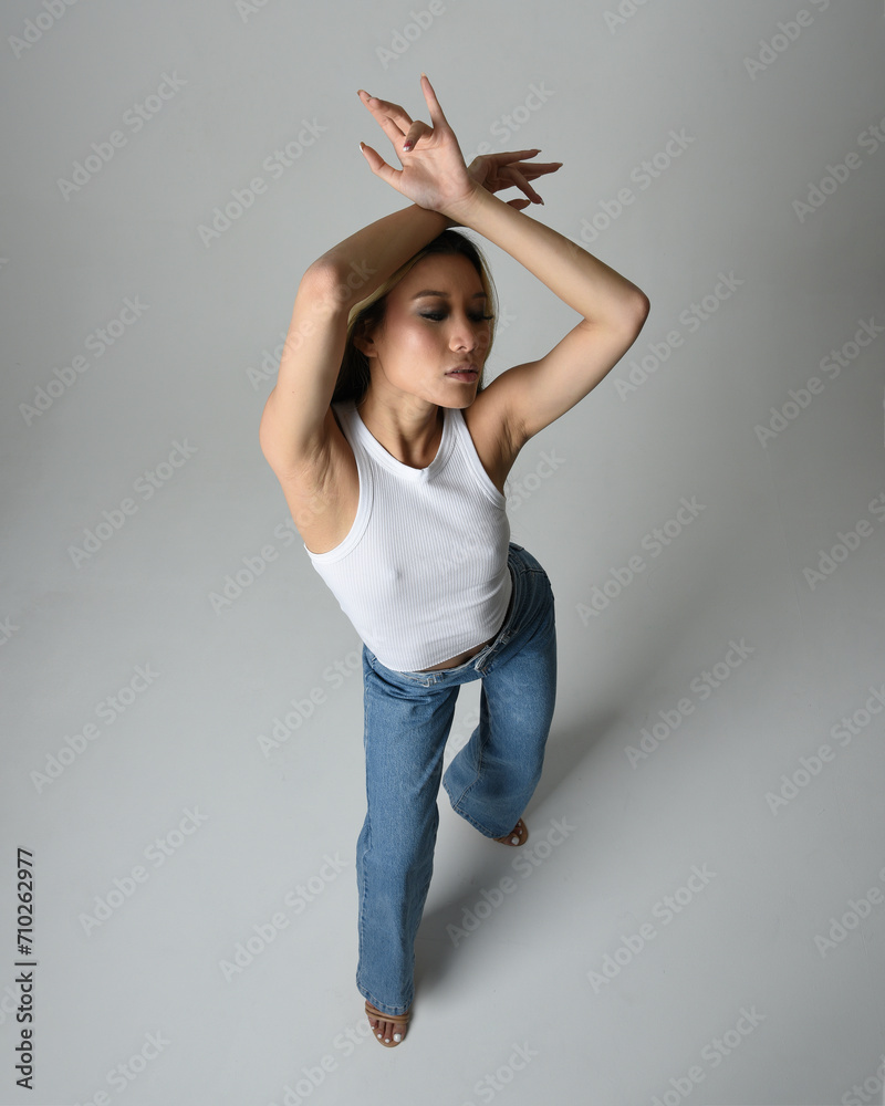 Full length portrait of brunette female asian model wearing casual ...