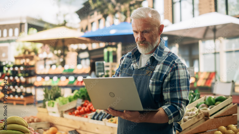 Successful Adult Male Farmer Working on a Laptop Computer, Checking ...