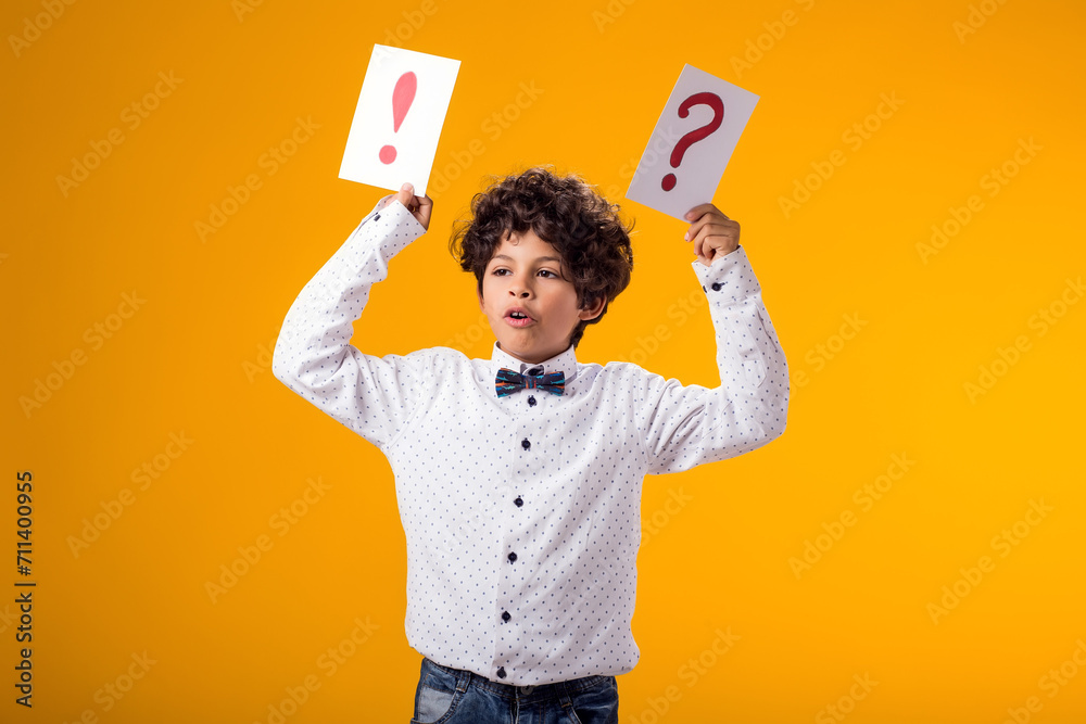Child boy holding question mark and exclamation point cards ...