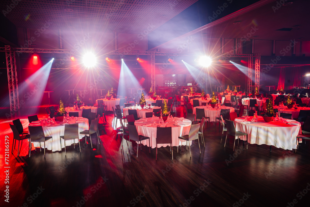 banquet hall with tables set for a festive event, illuminated by ...