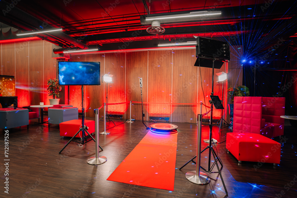 360 spinner photo booth setup in an event space with ambient red ...