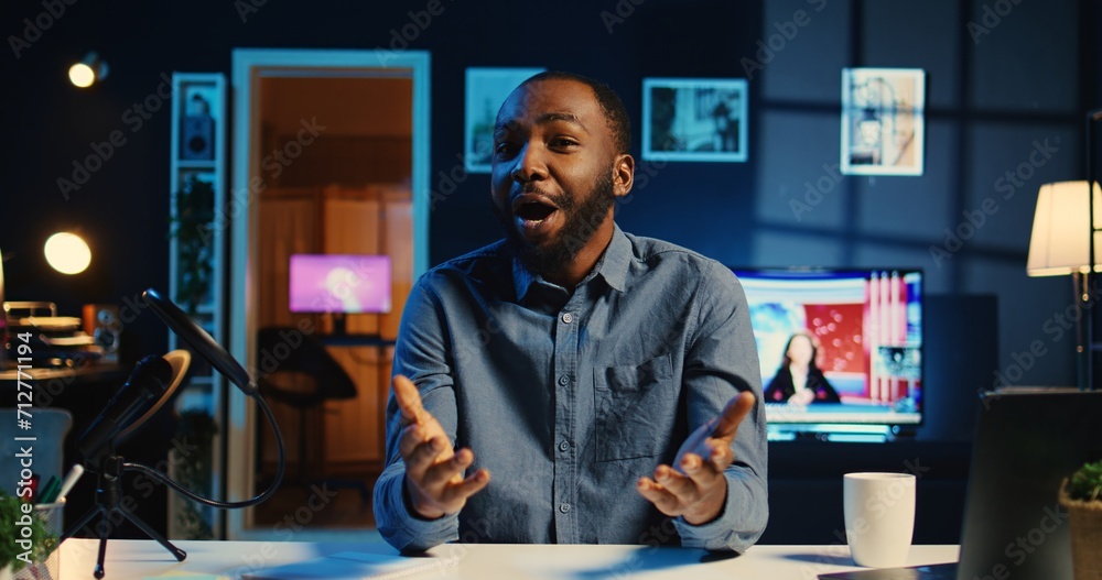 Happy influencer in home studio using professional camera and mic to ...