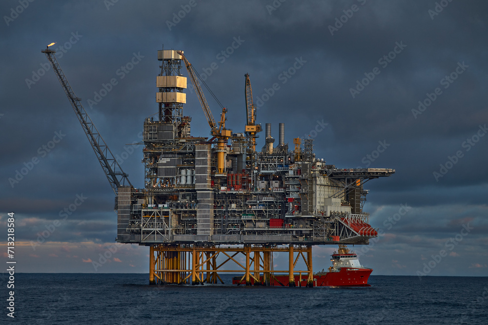 Supply vessel doing cargo operations with jack up drilling rig ...