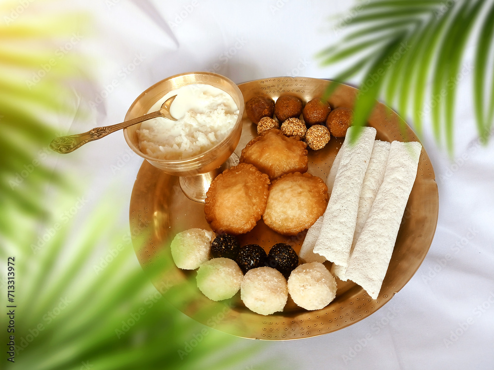 Assamese traditional food items like pitha, laddu, doi sira with ...