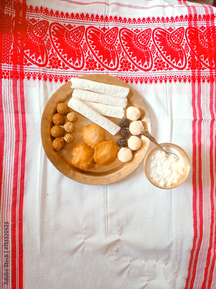 Assamese traditional food items like pitha, laddu, doi sira with ...