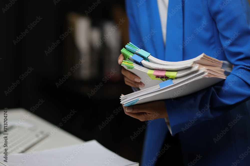 Businesswoman hands working in Stacks of paper files for searching and ...