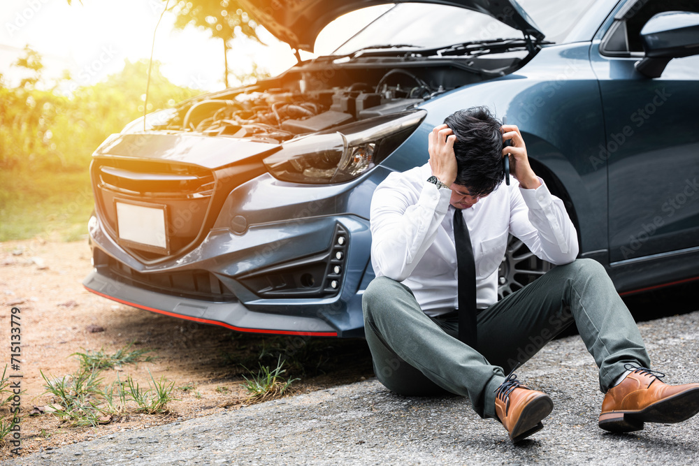 Young businessman wearing white shirt and call roadside assistance ...