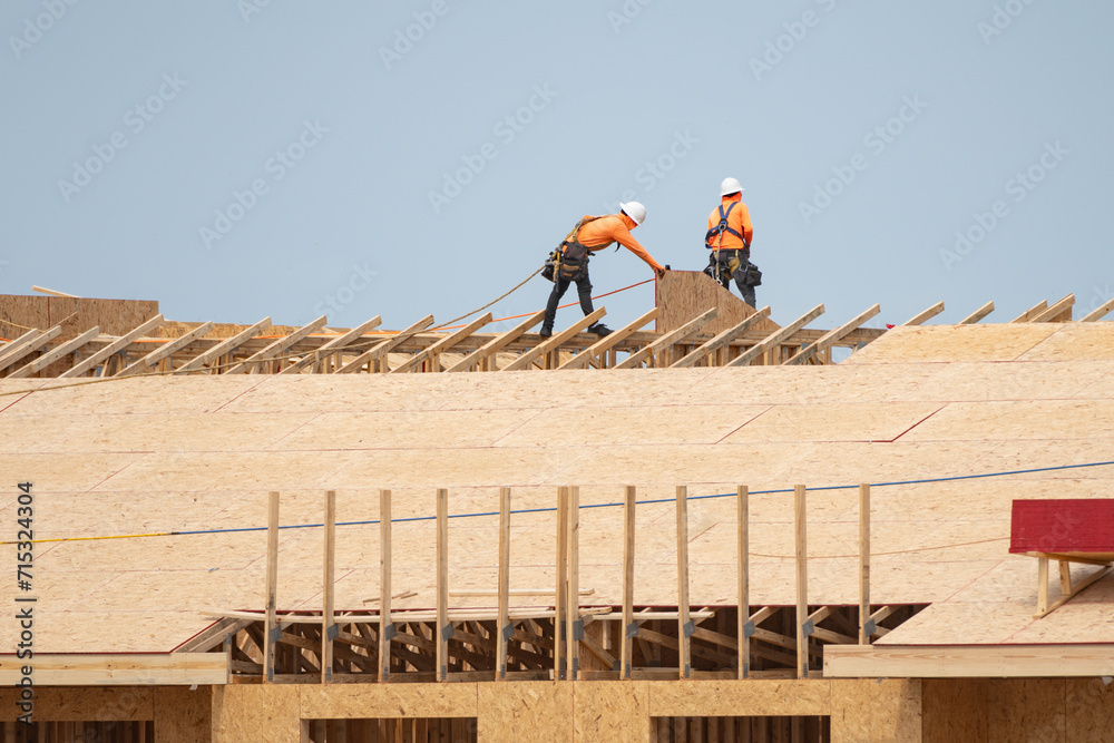 Preparing the roof deck for OSB installation. Cutting OSB sheets for ...