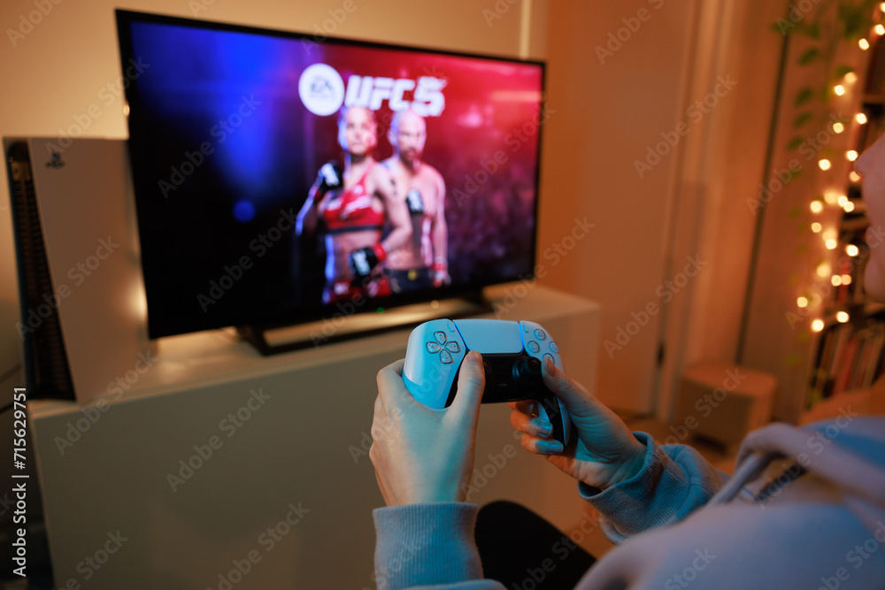 New UFC 5 Sony PS5 console. Dualsense controller. Man holding joystick ...